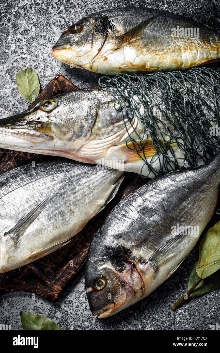 Fresh unprepared fish. On a rustic background Stock Photo - Alamy
