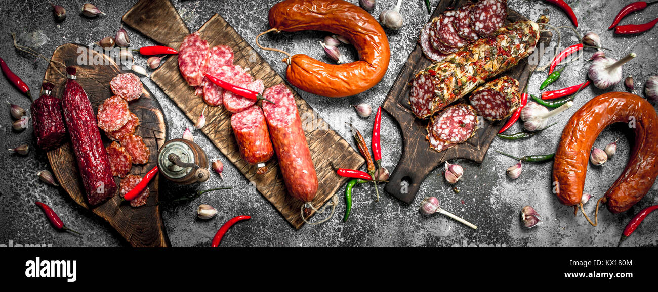 Salami background. Different kinds of salami with spices. On a rustic ...