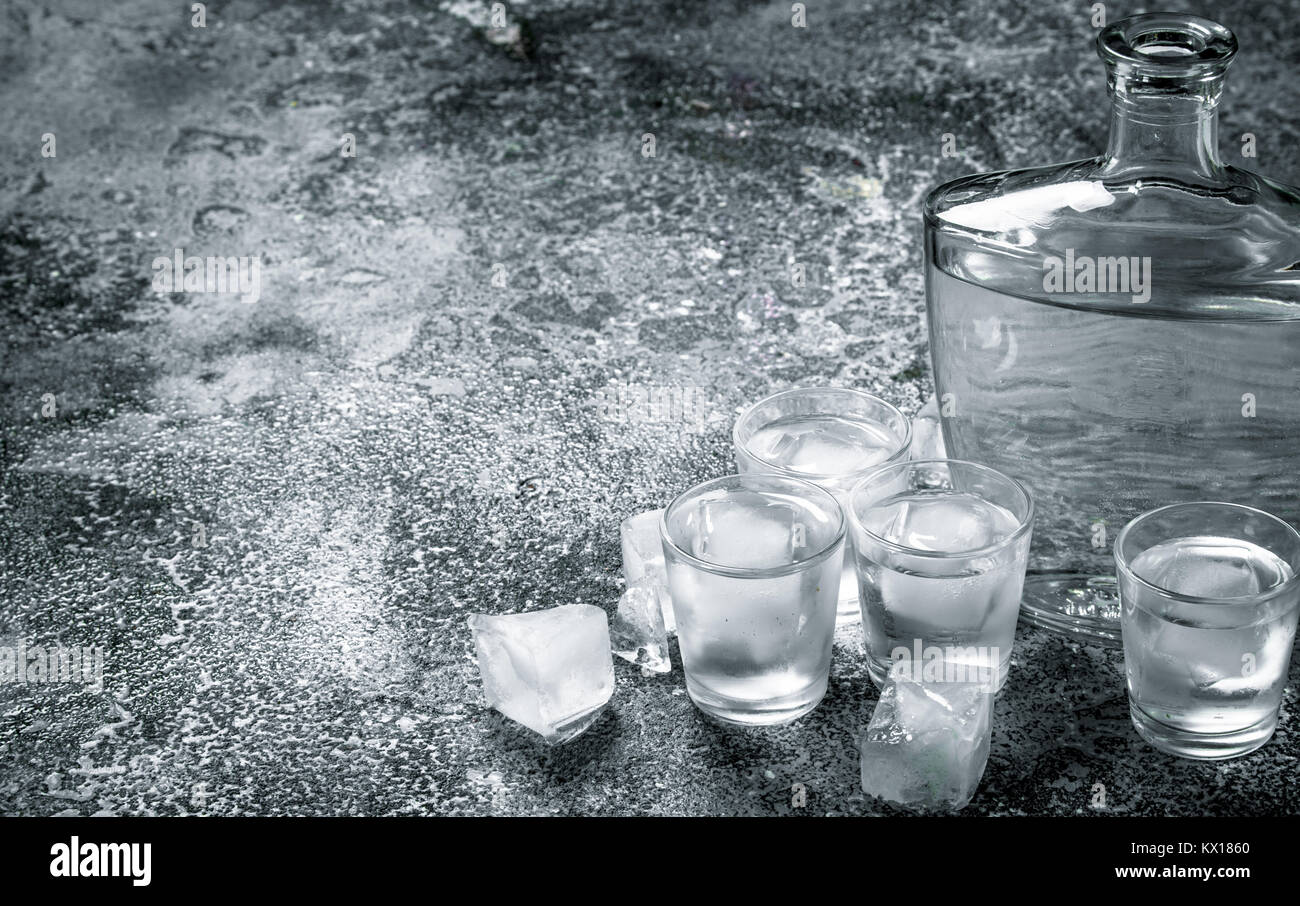 Vodka with ice in glasses. On a rustic background Stock Photo - Alamy
