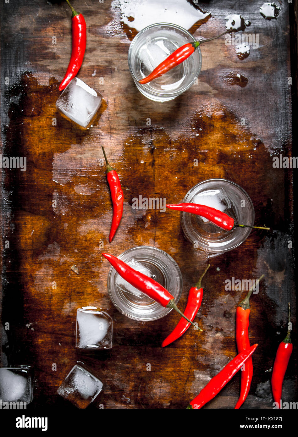 Vodka shots with chili pepper. On a wooden background Stock Photo - Alamy