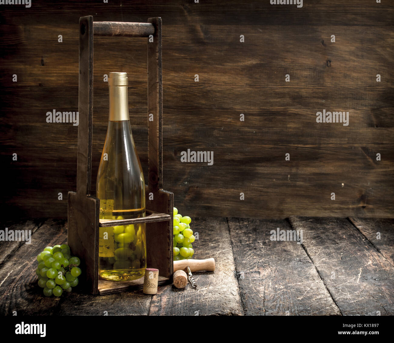 Wine background. White wine on a stand with branches of fresh grapes ...