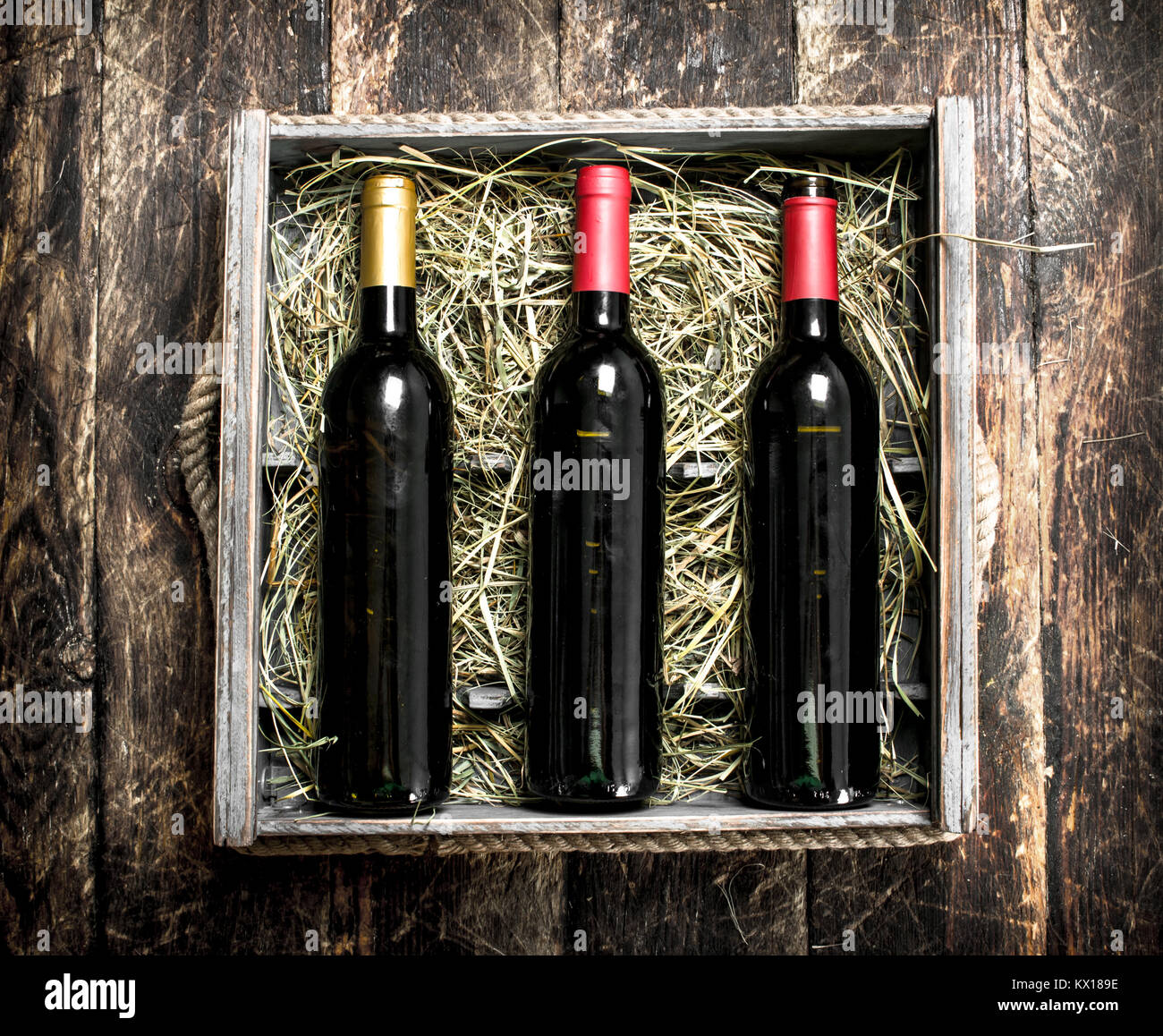 Wine in the box. On a wooden background Stock Photo - Alamy