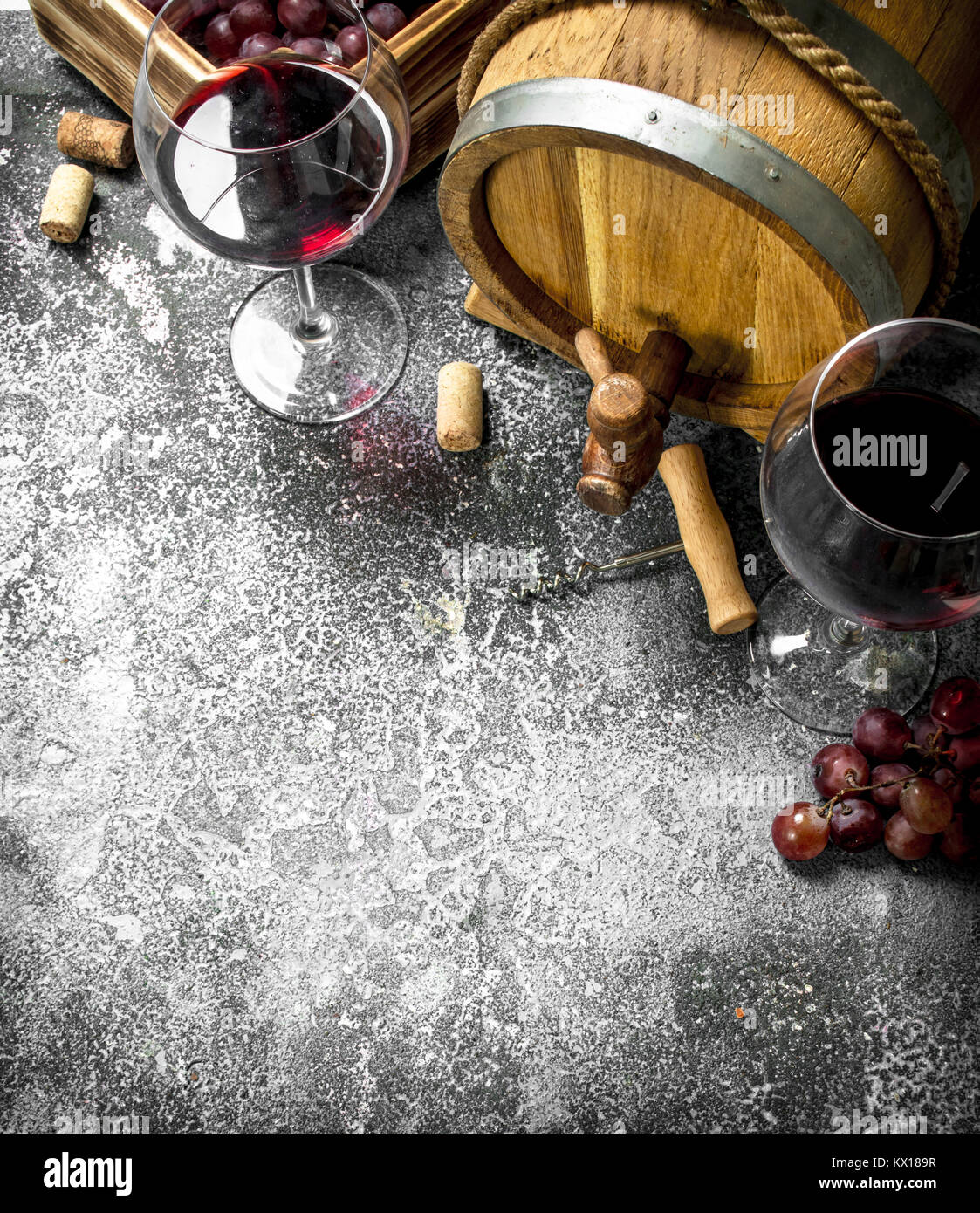 Wine background. A barrel with red wine and fresh grapes. On a rustic ...