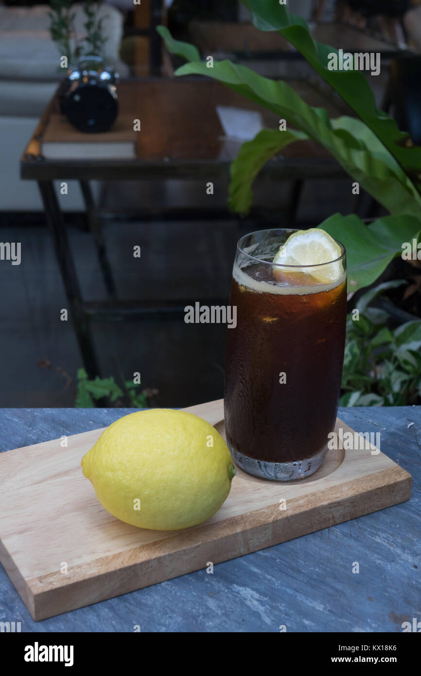 Iced cola glass with lemon Stock Photo - Alamy