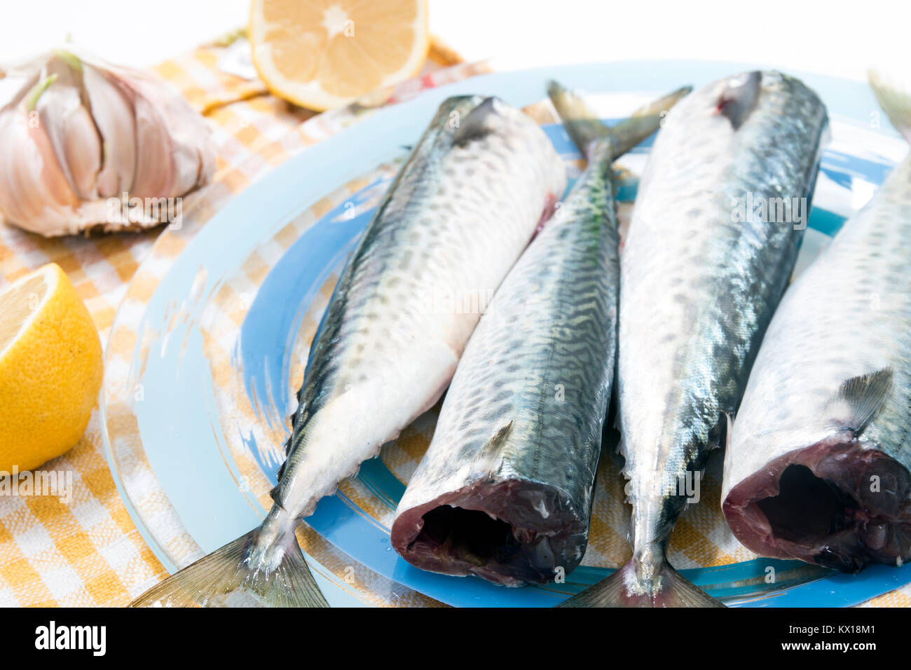 Raw mackerel fish on a plate Stock Photo - Alamy