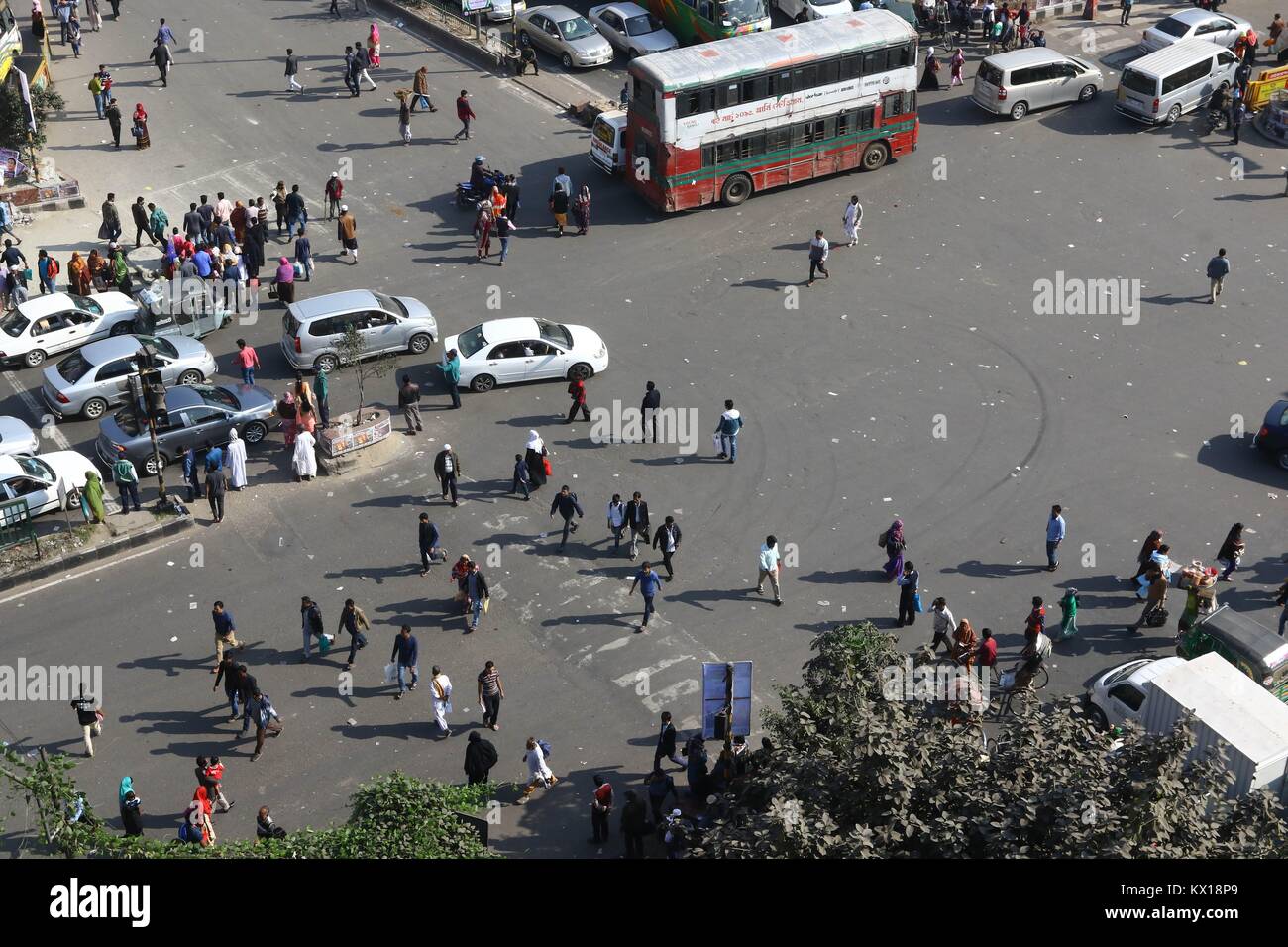 Street car traffic and crowd of people walking Across Busy Road in ...