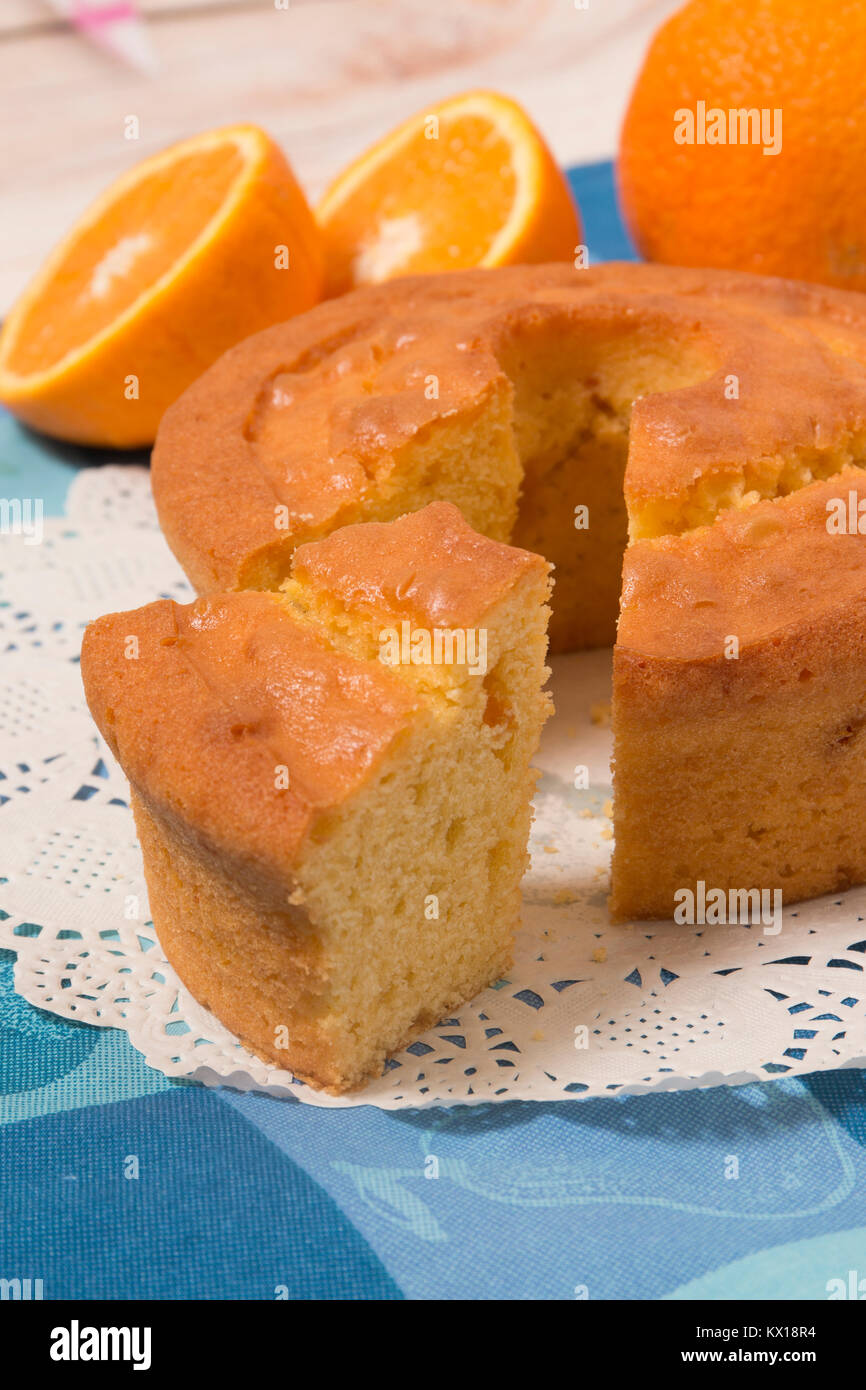 Homemade orange cake on a table with fruit sliced Stock Photo - Alamy