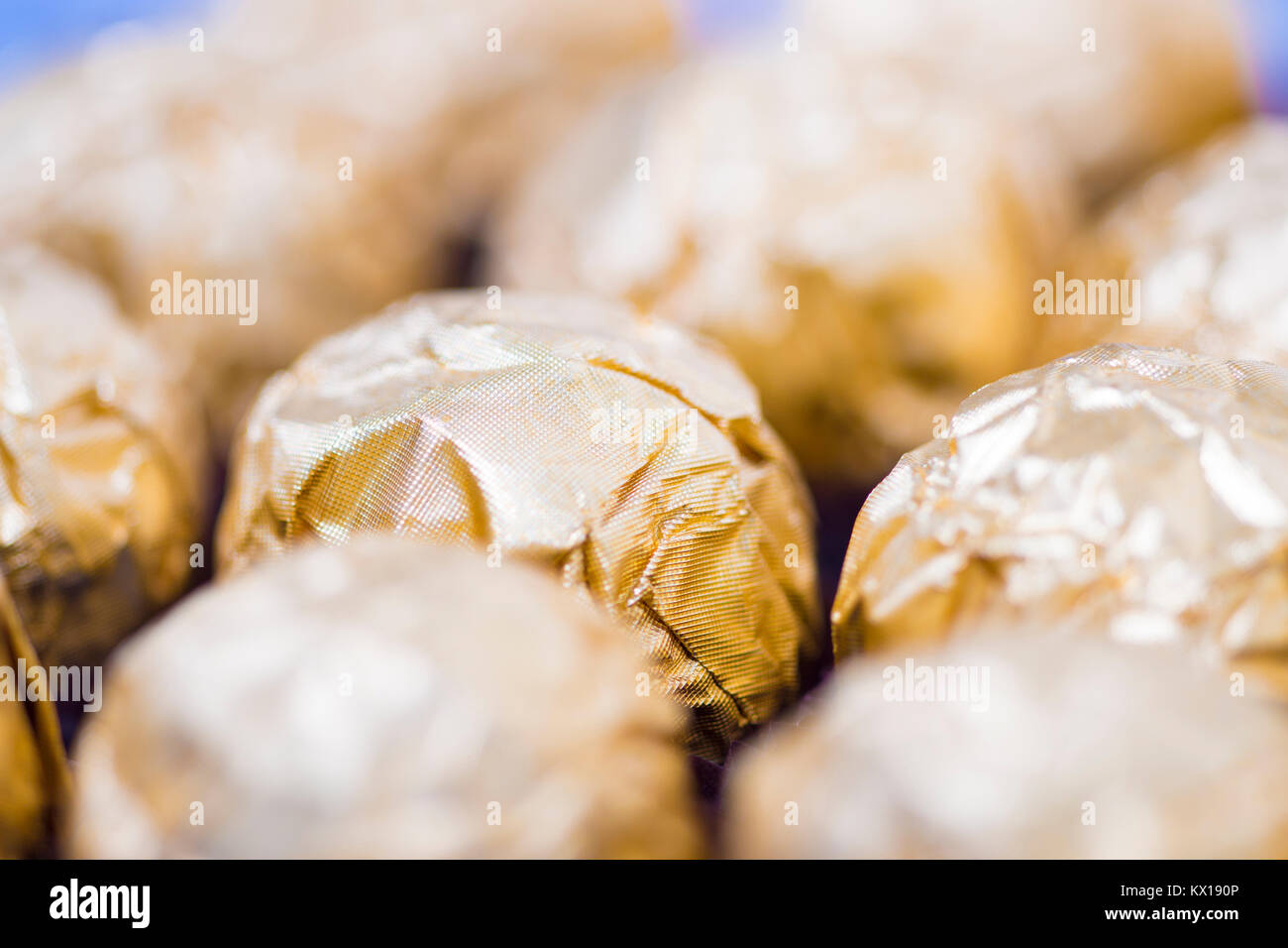 Chocolate candy balls wrapped on beautiful golden paper Stock Photo - Alamy