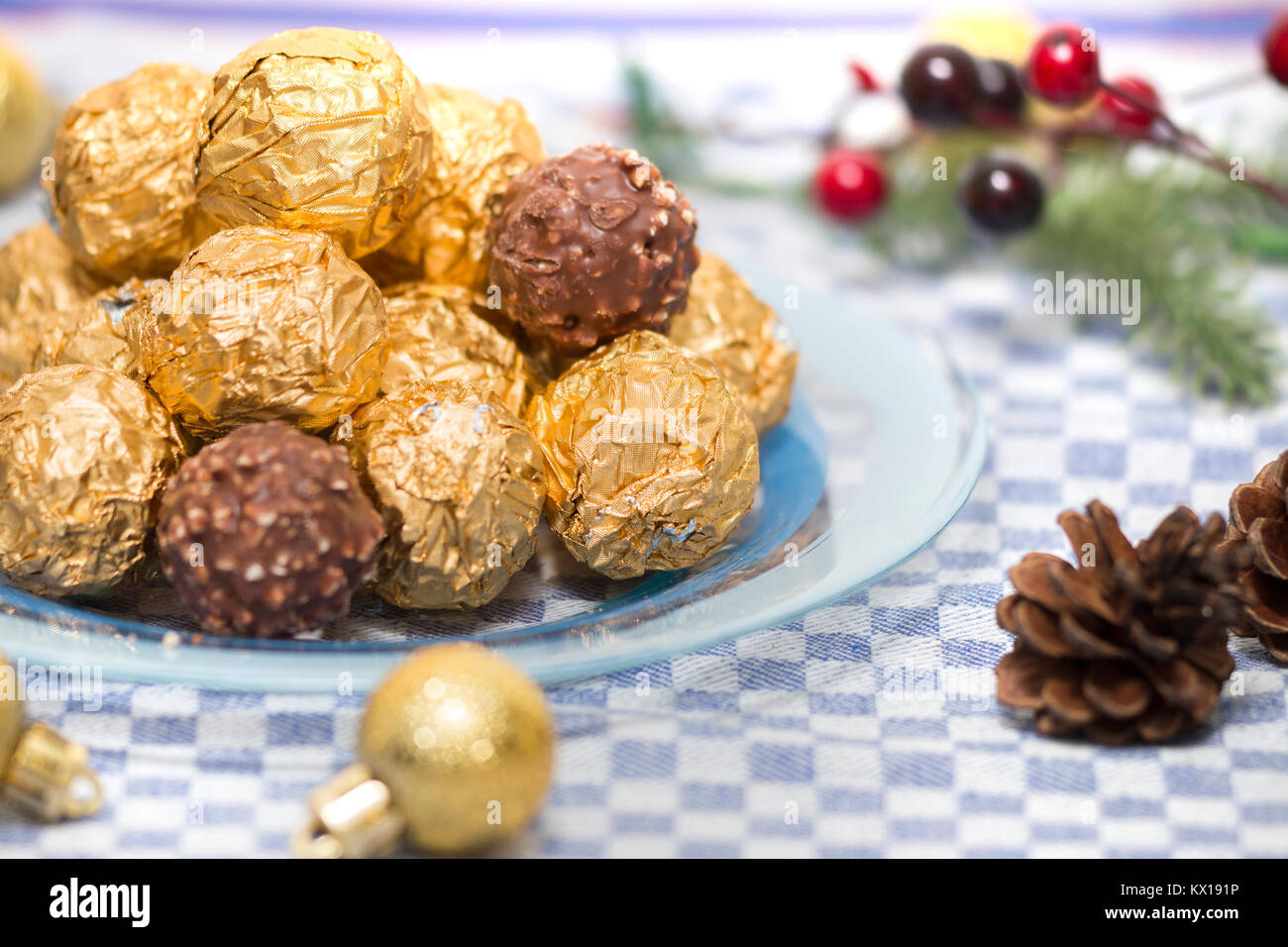 Chocolate candy balls wrapped on beautiful golden paper with xmas ...