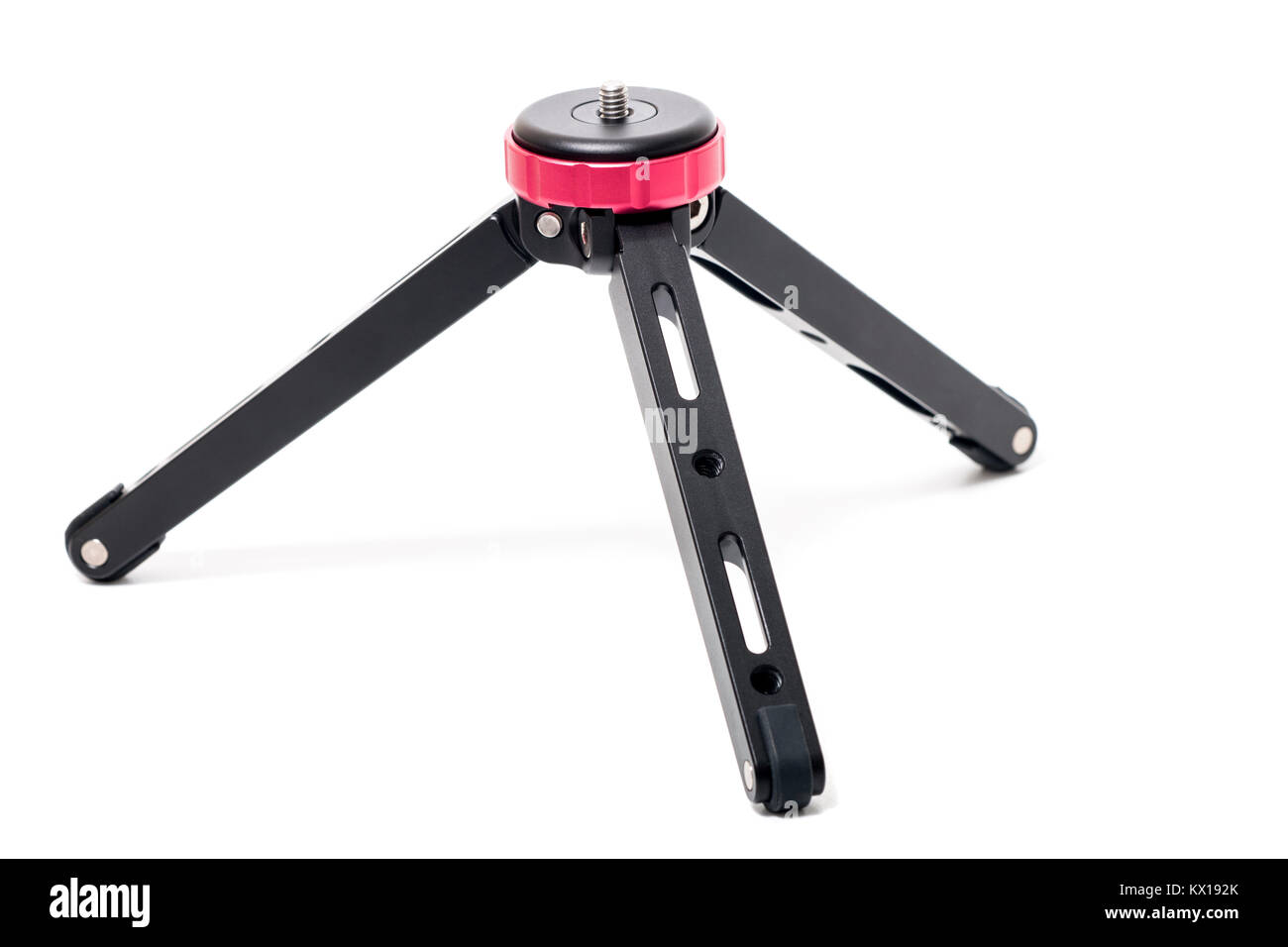 Close up view of a low ground tiny camera tripod isolated on a white ...