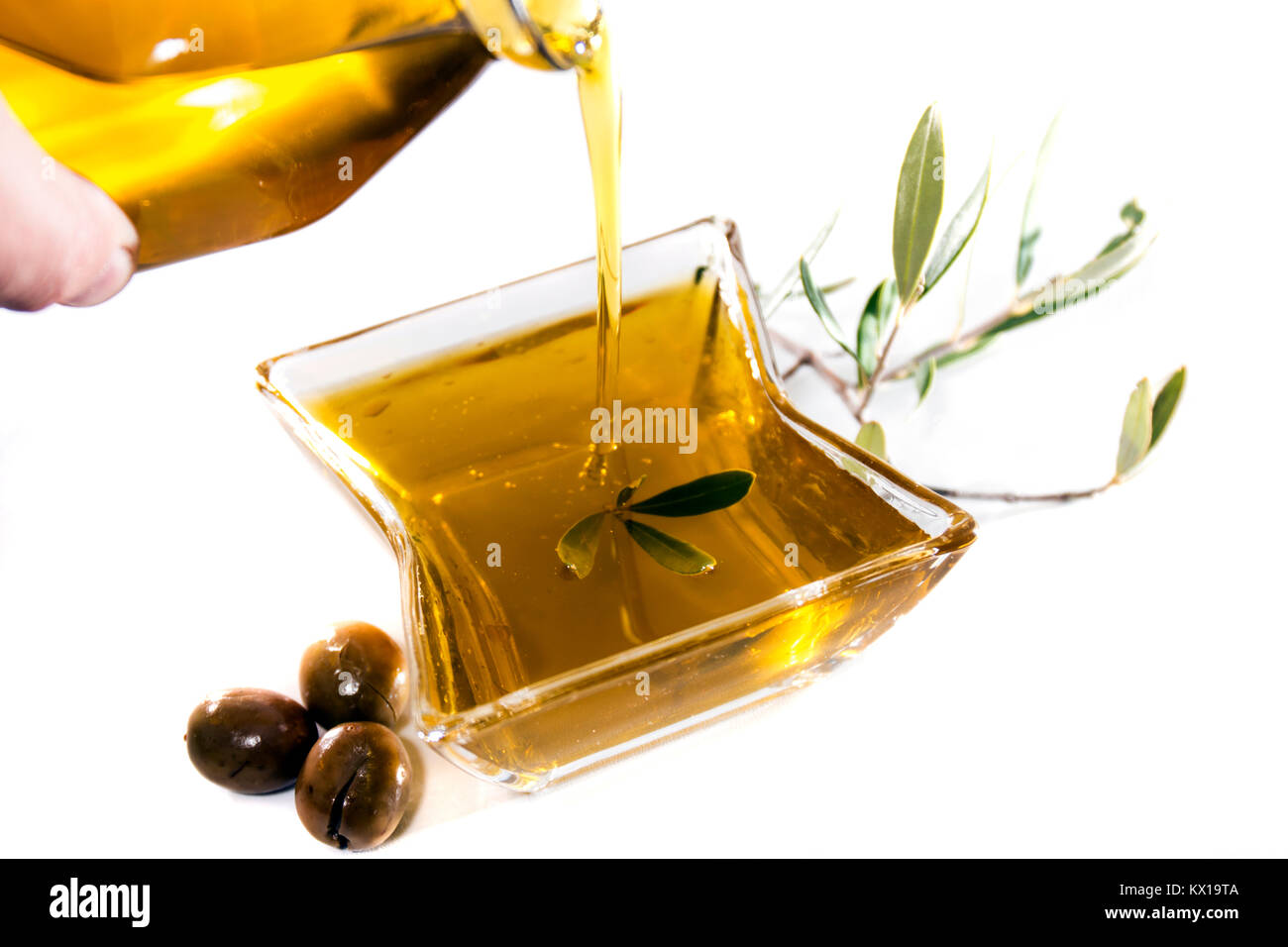 Pouring olive oil in container isolated on a white background Stock ...