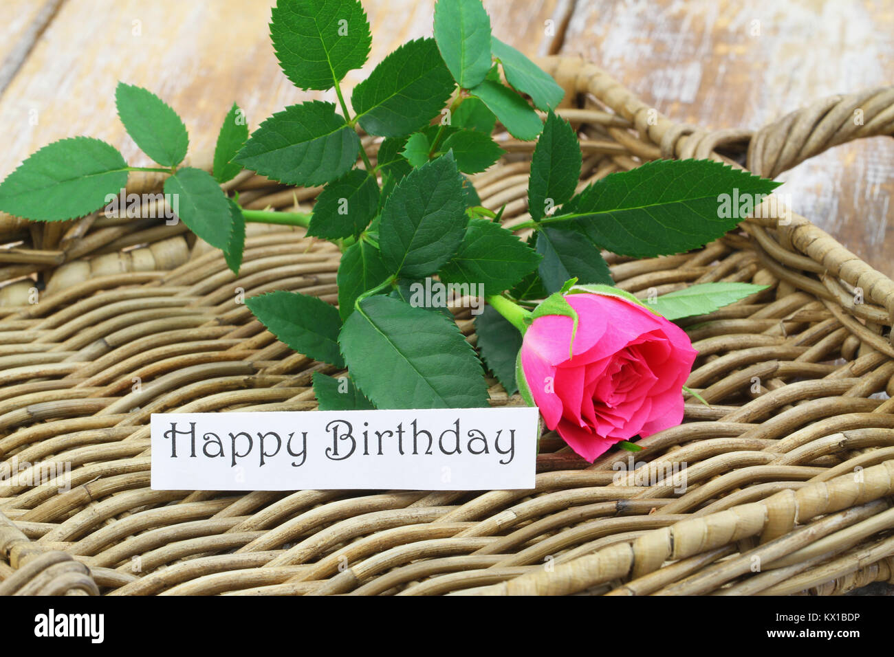 Happy Birthday card with pink rose on wicker tray Stock Photo - Alamy