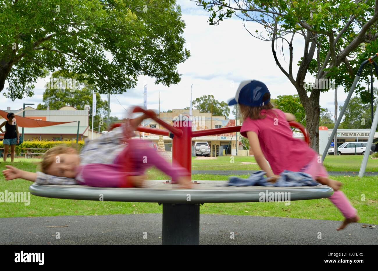 Children playing on a roundabout hi-res stock photography and images ...