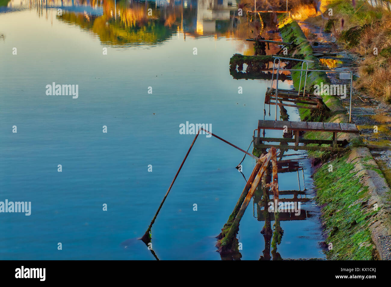 Platforms and piers of rusted and encrusted iron on water channel Stock ...