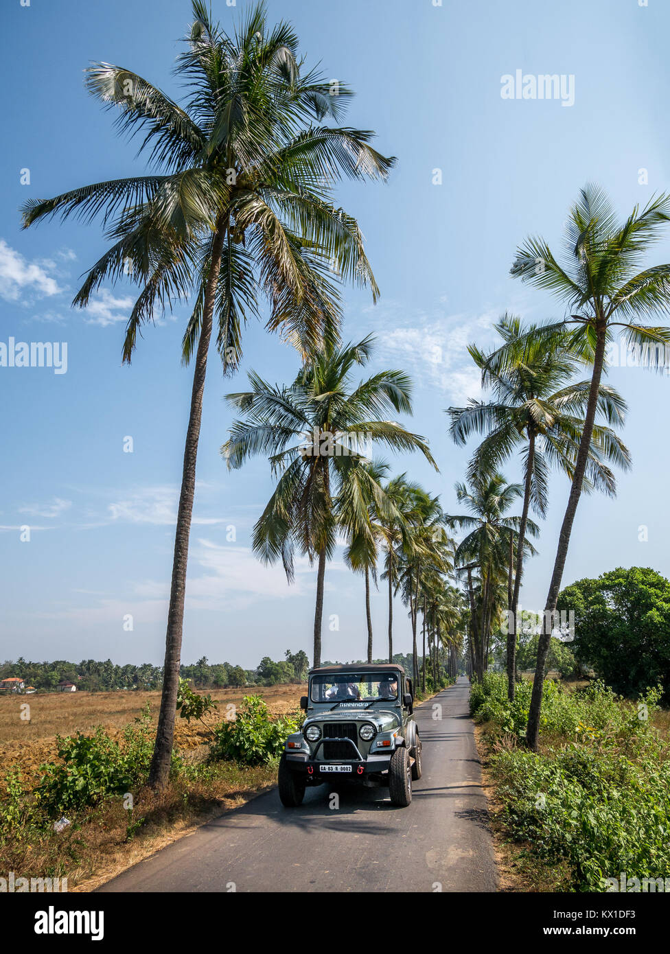 Goa, India - December 21, 2017 : An open jeep passing an empty road in ...