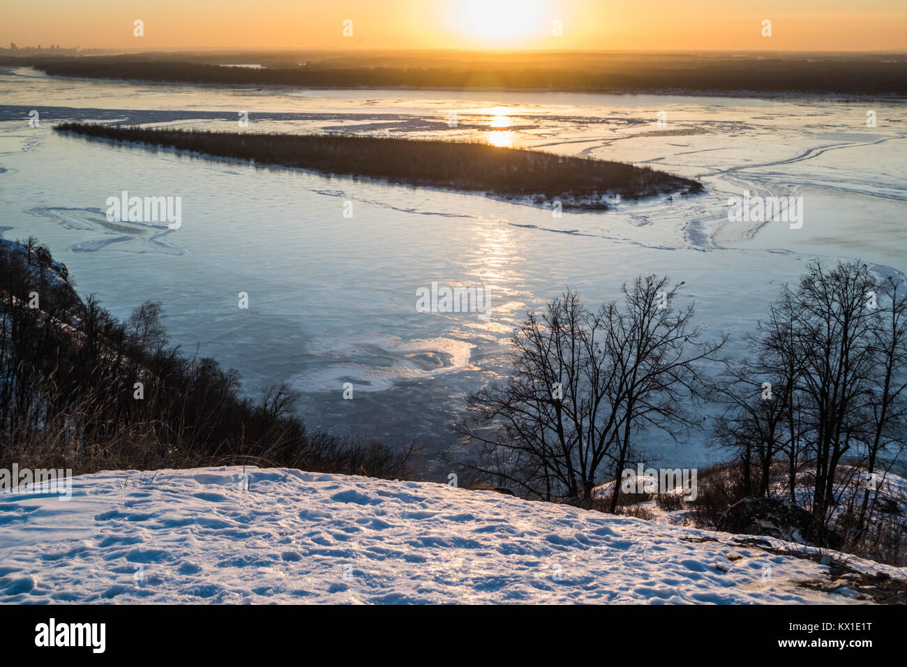Panoramic view on frozen Volga river in winter during sunset from hill ...