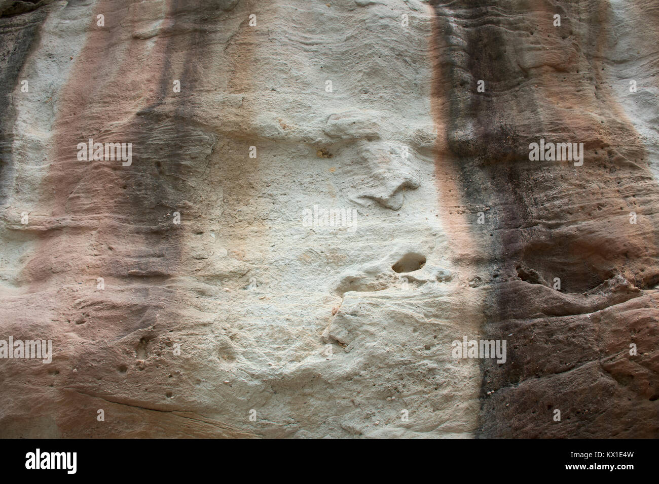 Rock art includes both humanoid and animal figures on cliffs above the ...