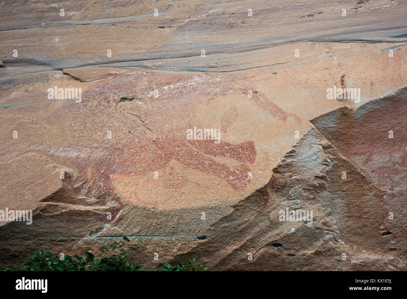 Rock art includes both humanoid and animal figures on cliffs above the ...