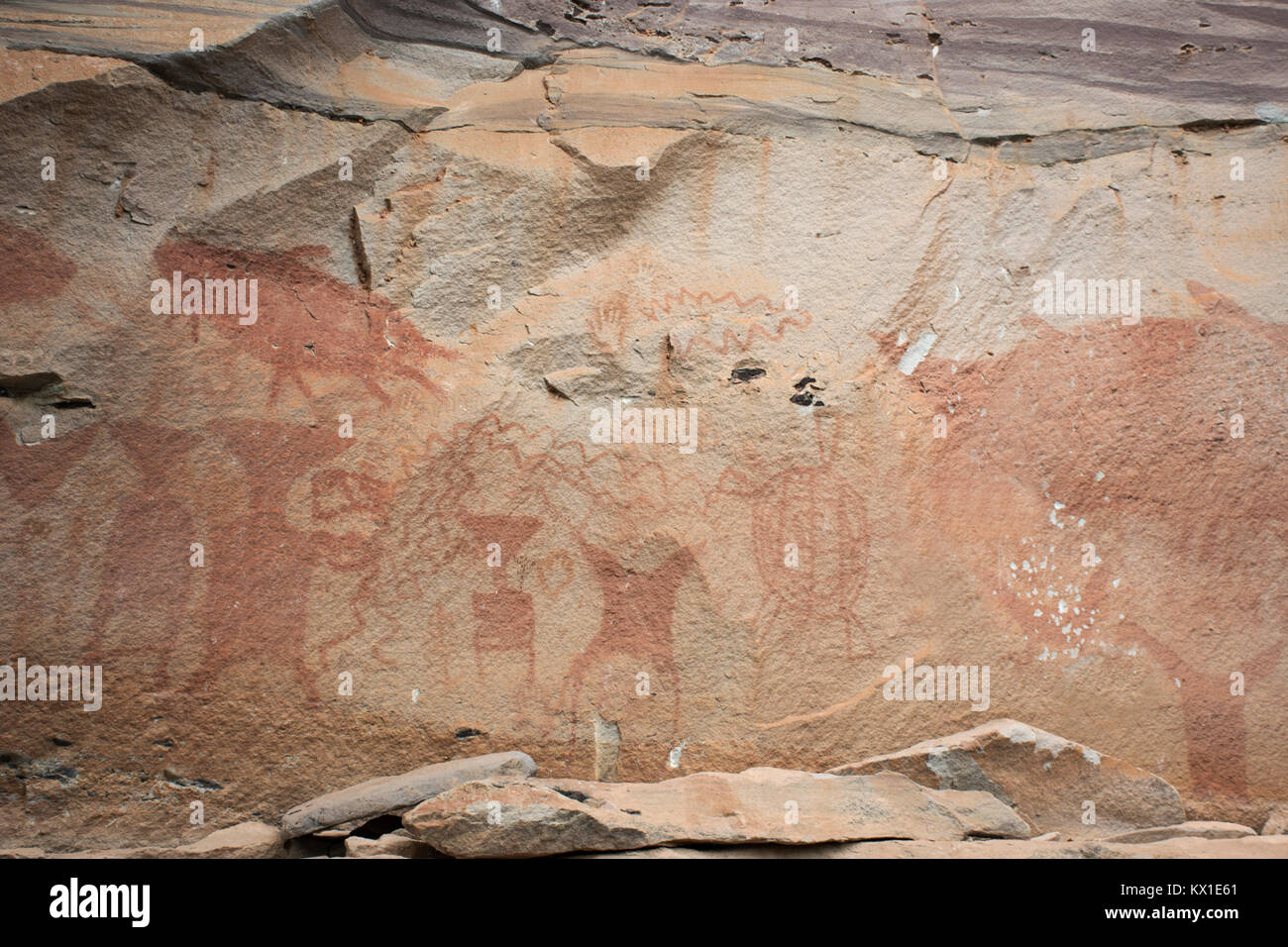 Rock art includes both humanoid and animal figures on cliffs above the ...