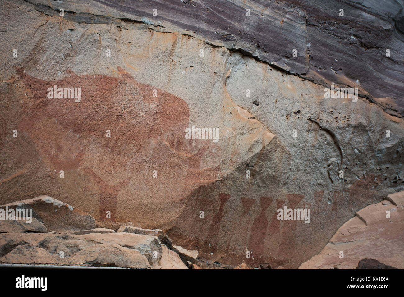 Rock art includes both humanoid and animal figures on cliffs above the ...