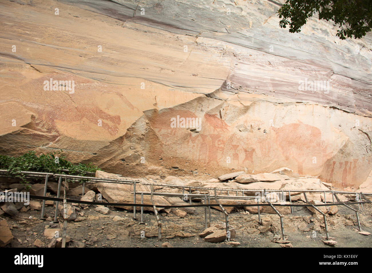 Rock art includes both humanoid and animal figures on cliffs above the ...