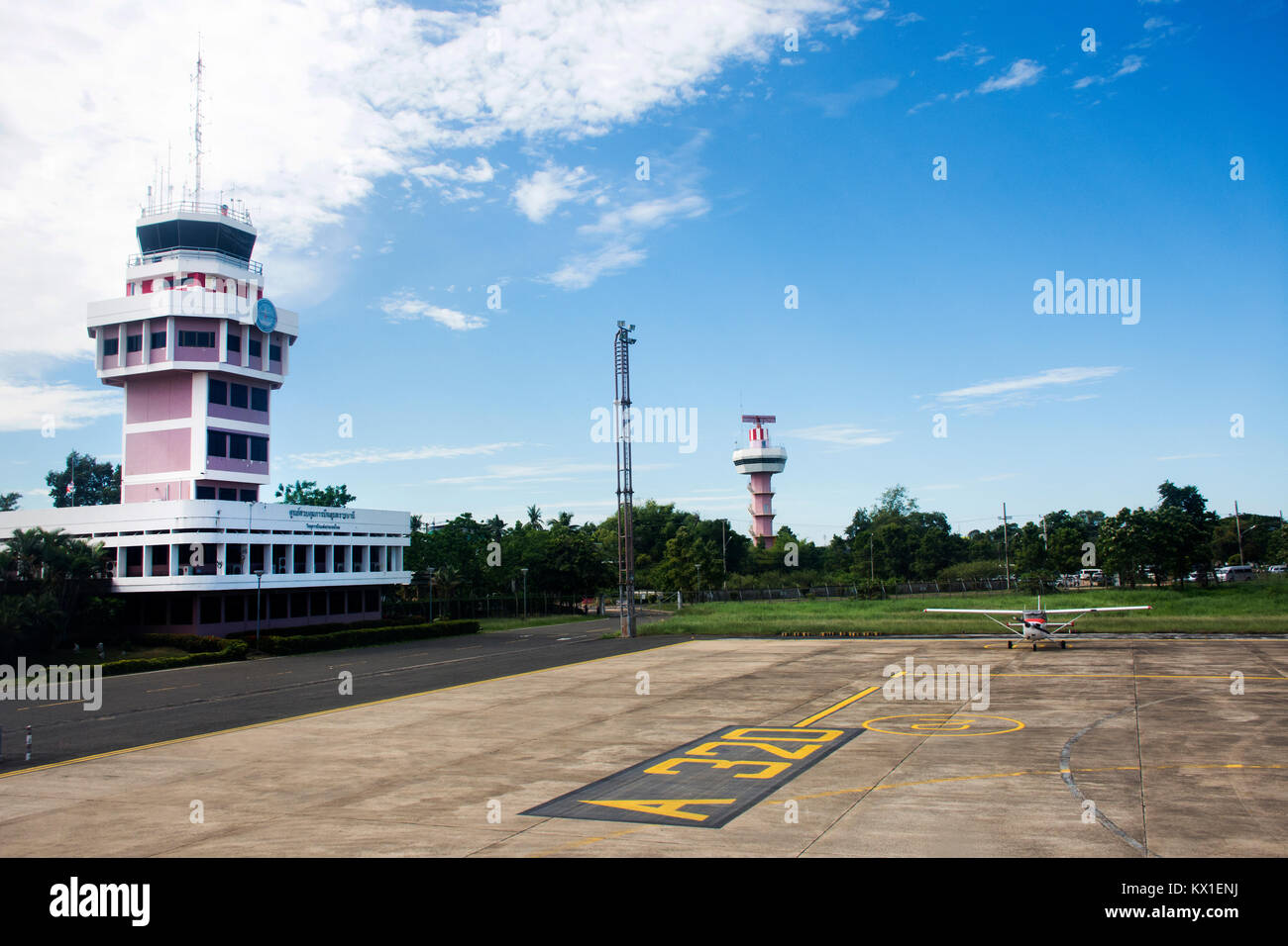 Air Traffic Control tower and Small plane stop on runway at Ubon ...