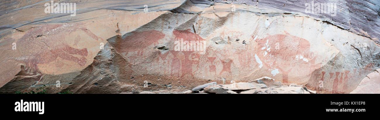 Rock art includes both humanoid and animal figures on cliffs above the ...