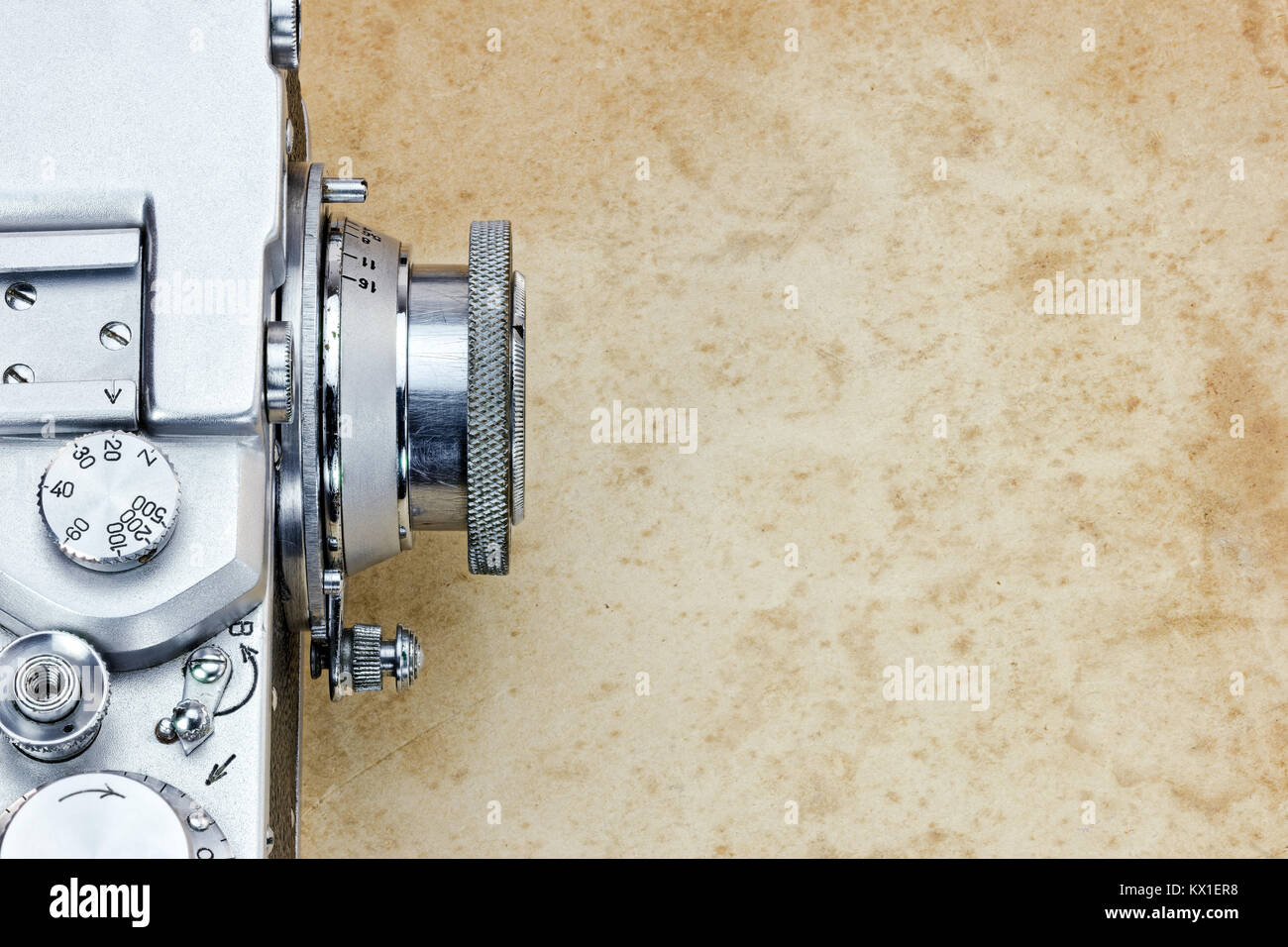 old still camera on grunge brown paper background with copy space macro ...