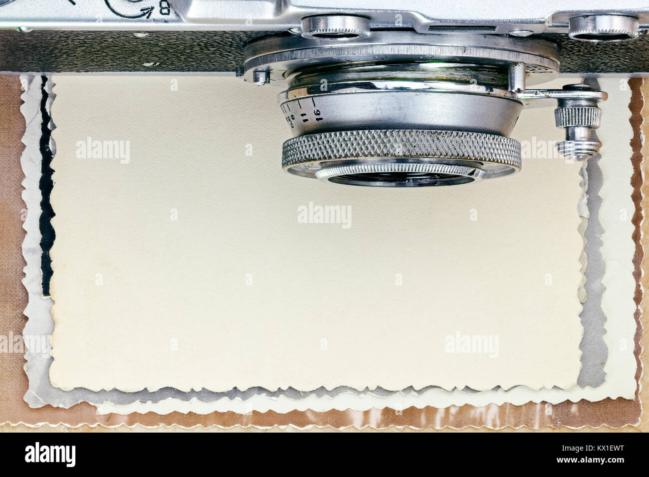 retro classic camera with pile of old photos on desk. view from above ...