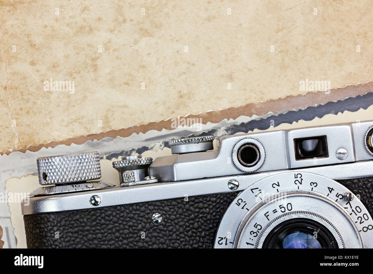 detailed view of classical camera with old photos on grunge paper ...