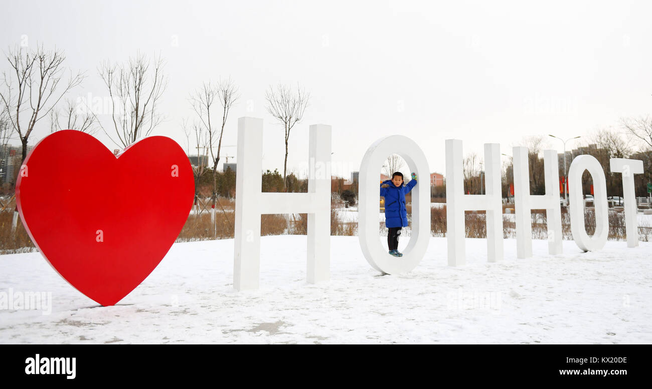 Hohhot. 7th Jan, 2018. A child poses for a photo in the snow in Hohhot ...