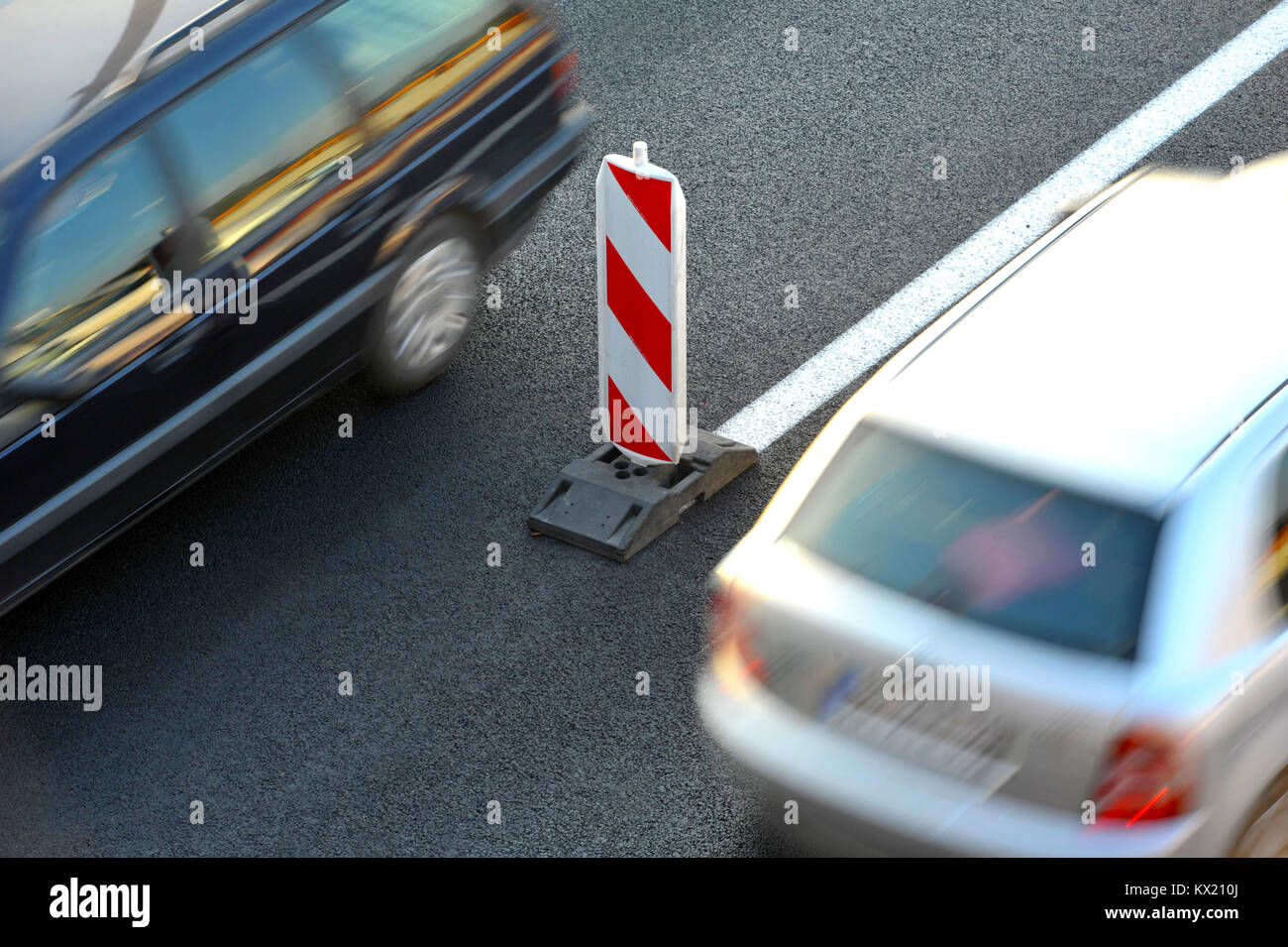 Moving Cars passing road sign Stock Photo - Alamy