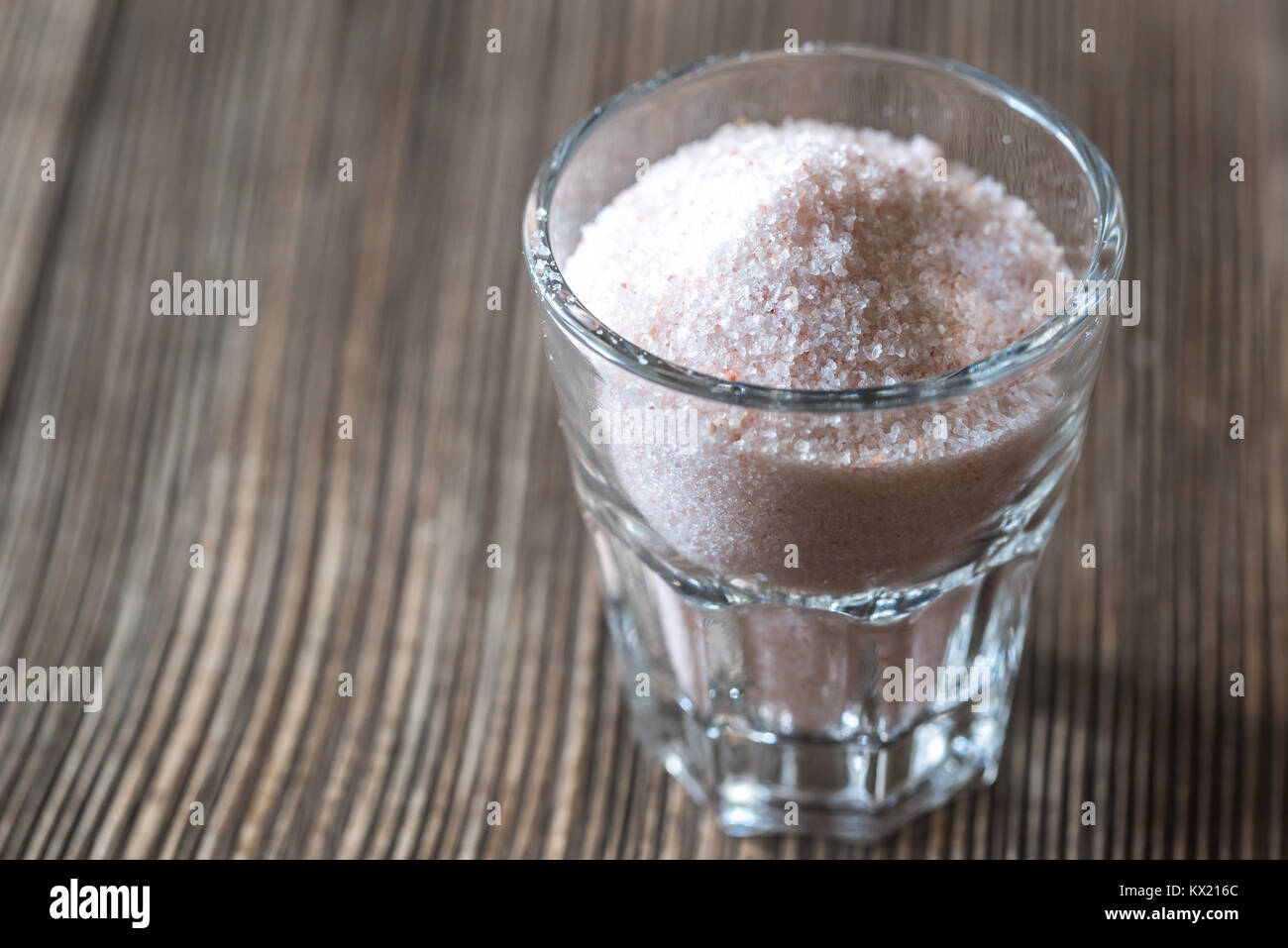 Glass of pink sea salt Stock Photo - Alamy