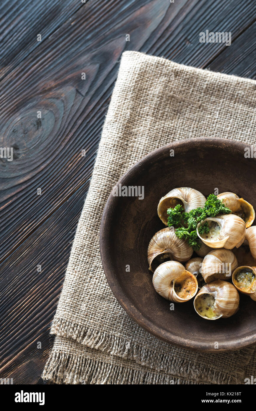 Bowl of cooked snails Stock Photo - Alamy