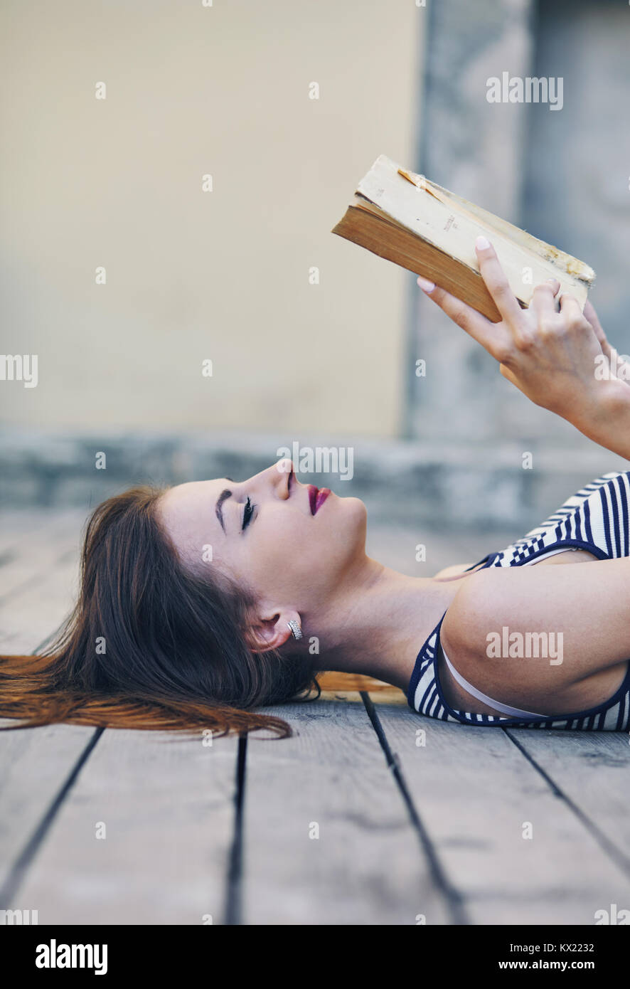 girl studying and reading a book. Relax, rest, education concept ...