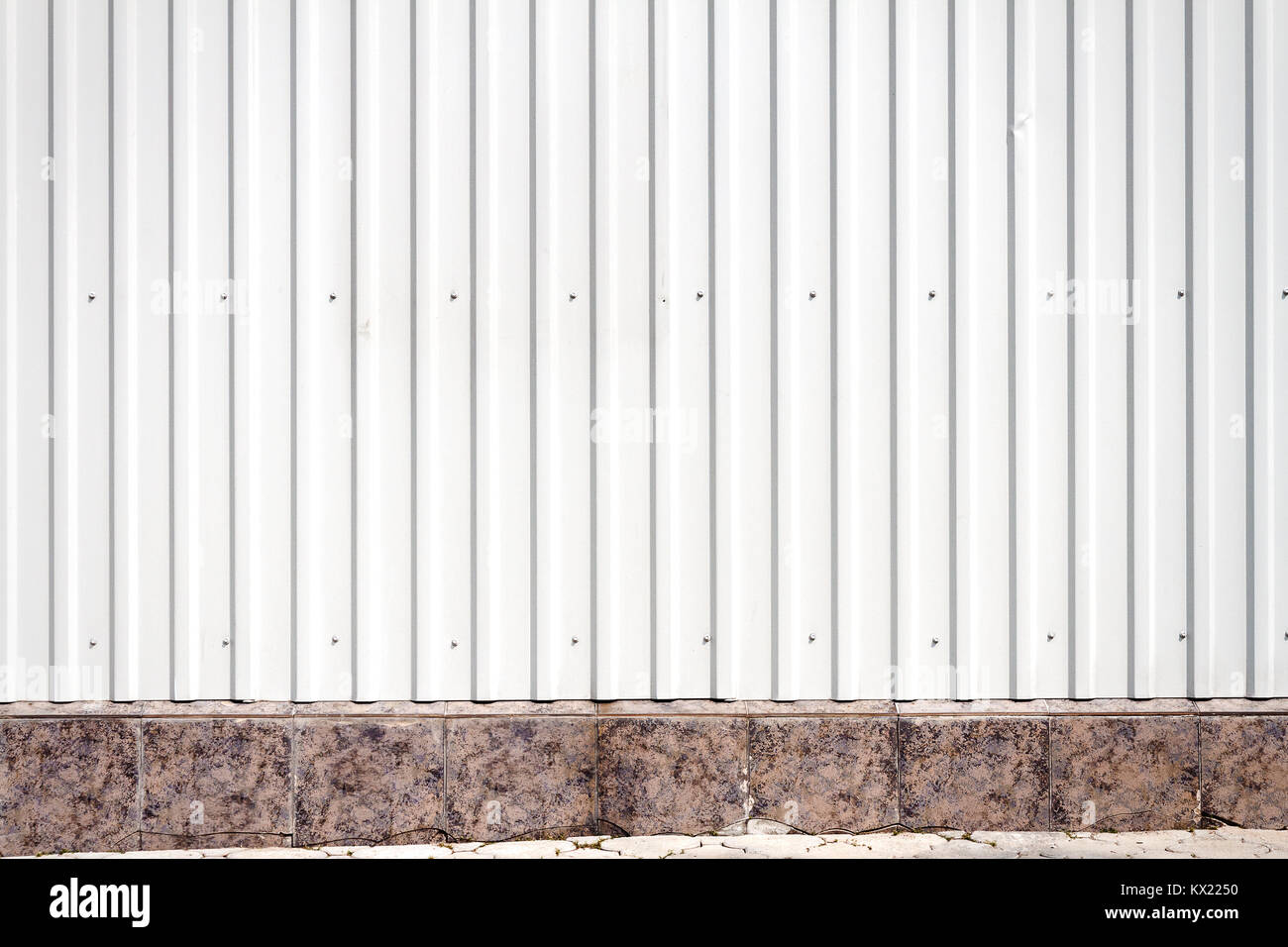 White industrial grooved metal wall with stone tile basement Stock ...