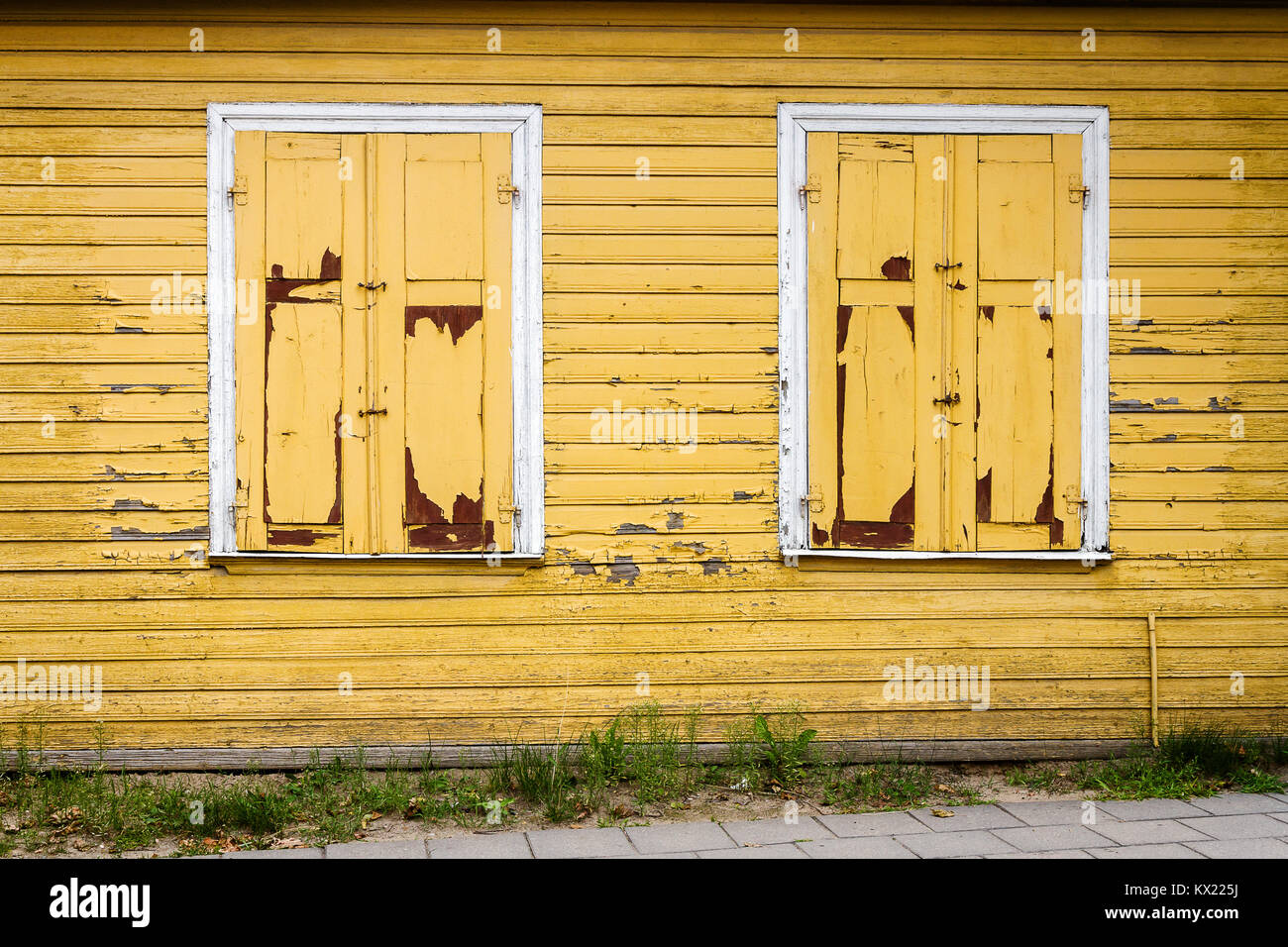 Old yellow wooden plank wall with some windows Stock Photo - Alamy