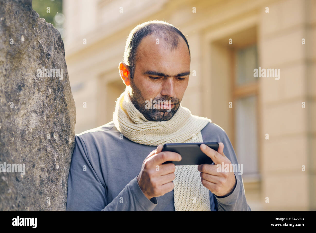 portrait of modern young man with mobile phone in the street Stock ...