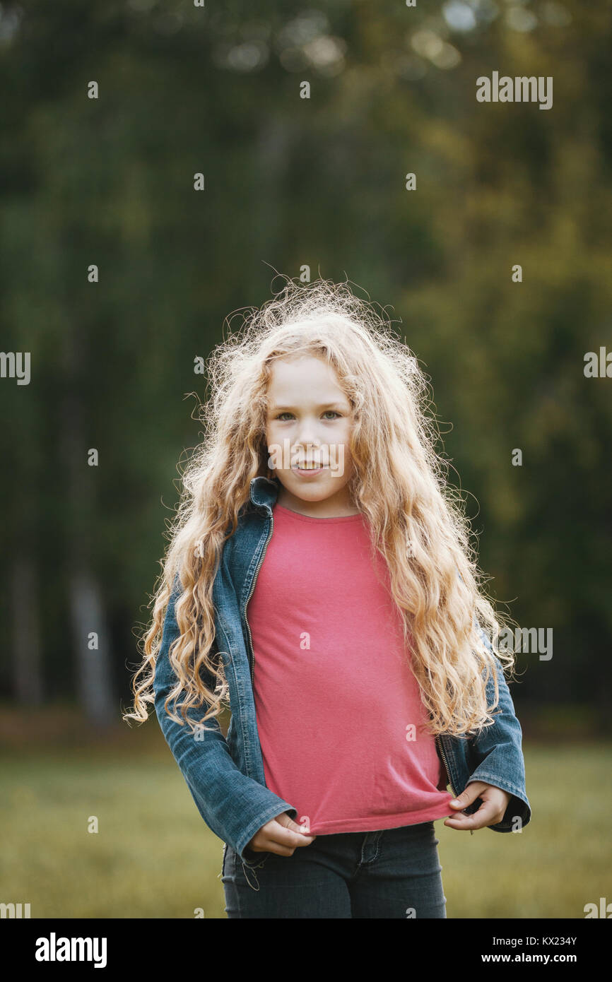 Pretty smiling child girl walking in park Stock Photo - Alamy