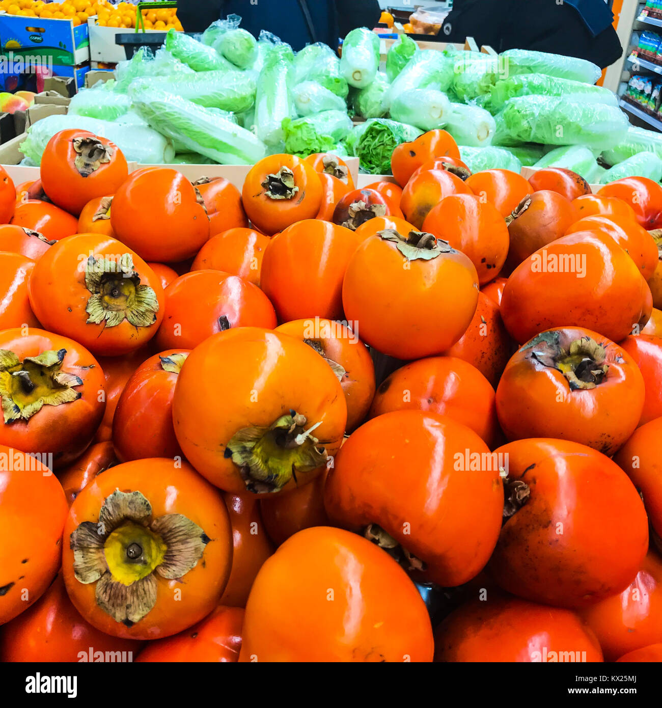 Sweet persimmon in the store Stock Photo - Alamy