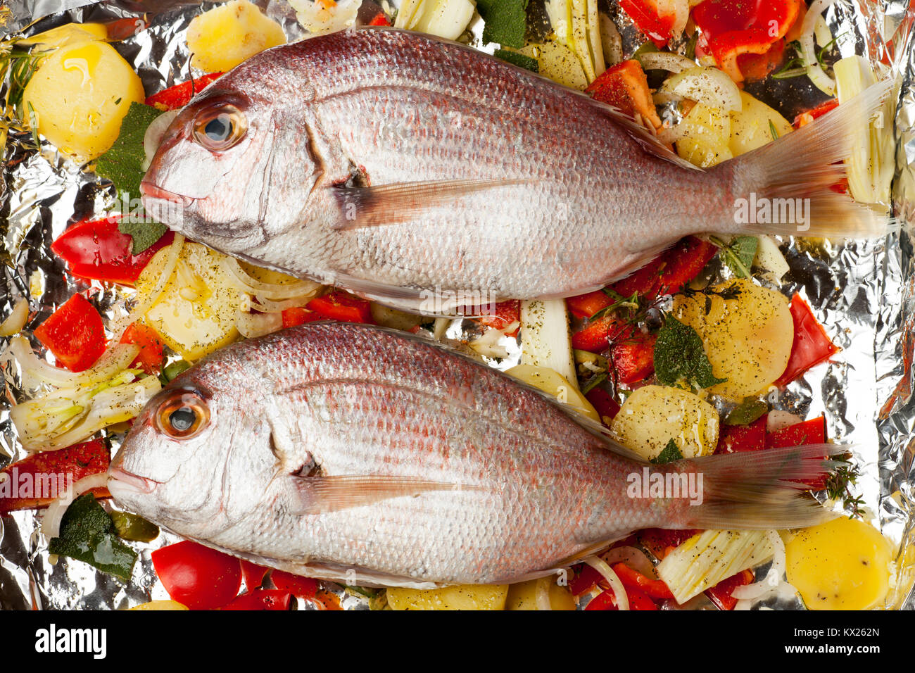 raw dorade with mixed vegetables Stock Photo - Alamy