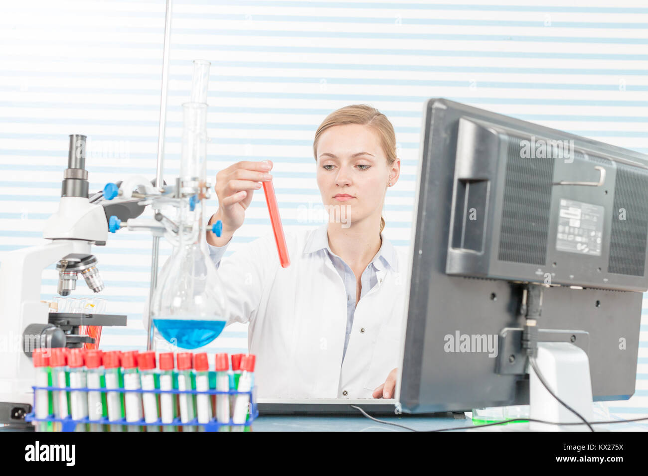 Experiments in the chemical laboratory, Female researcher using her ...