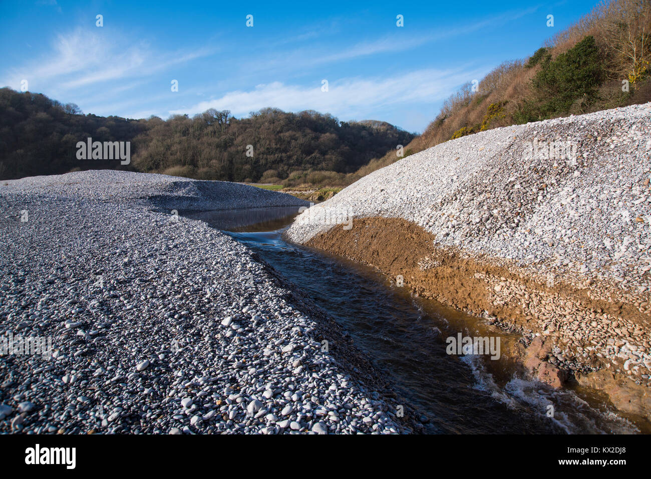Bishopston Valley Stream flowing through the deep stone beach at Pwlldu ...