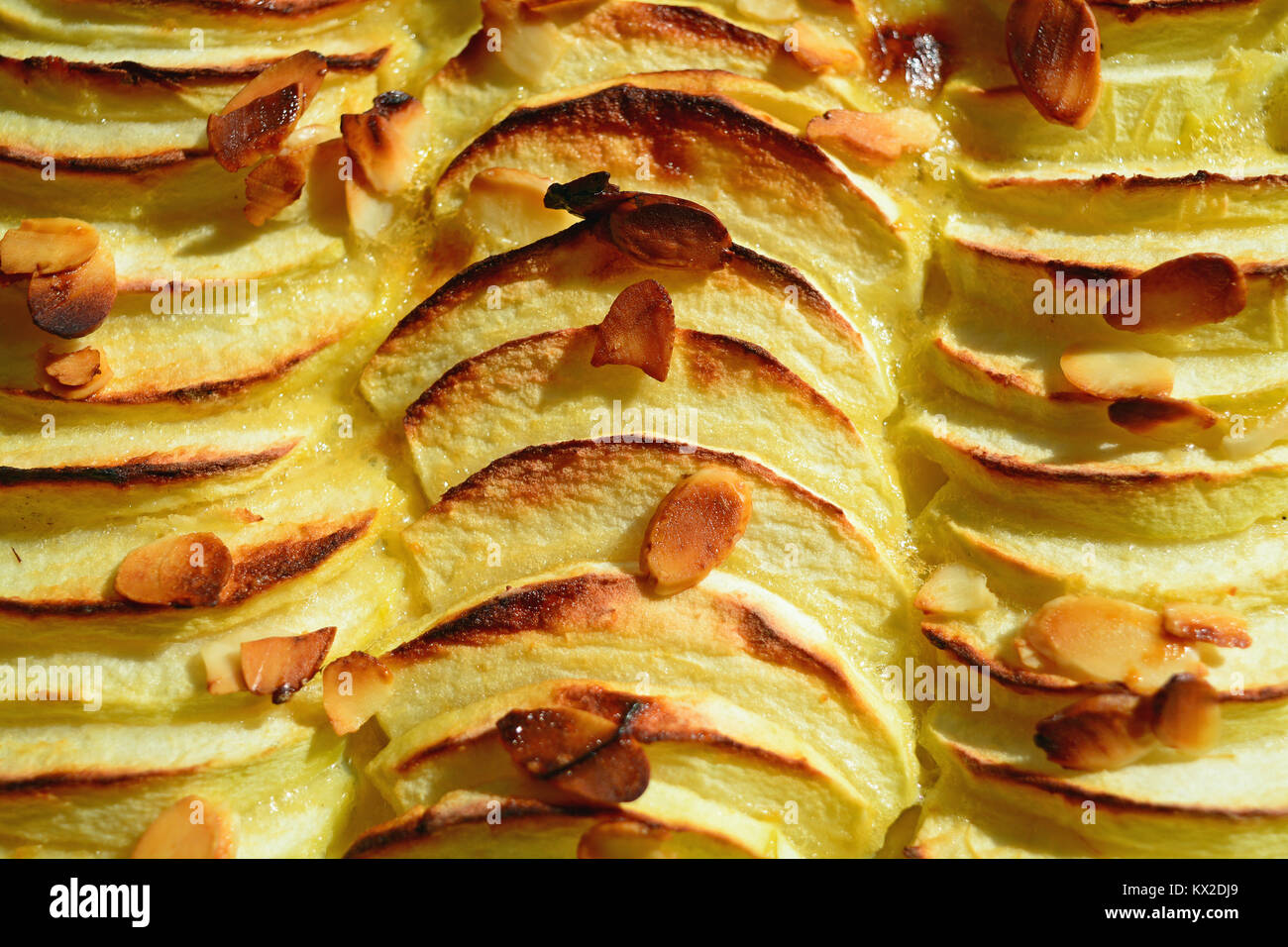 Detail of a freshly baked apple tart with almond slivers Stock Photo ...