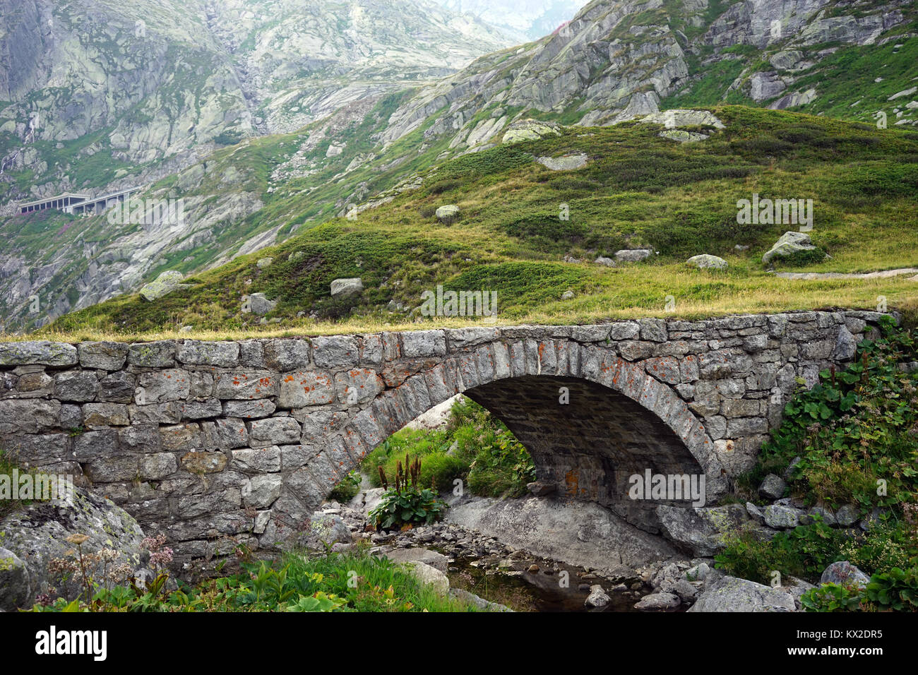 Stone bridge and road in Swiss Alps in Switzerland Stock Photo - Alamy