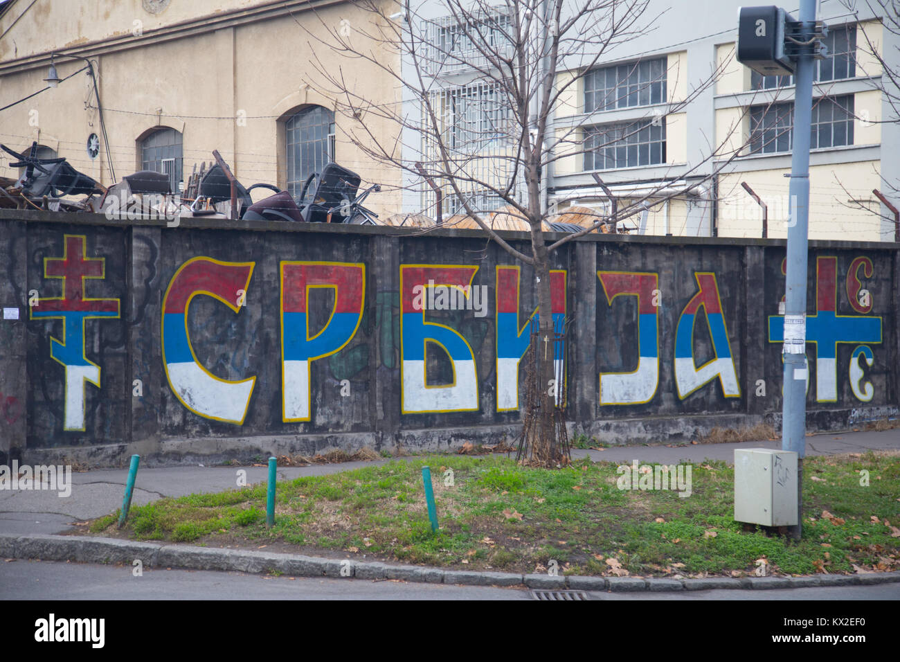 Mural graffiti with orthodox cross and name Serbia written in Serbian ...
