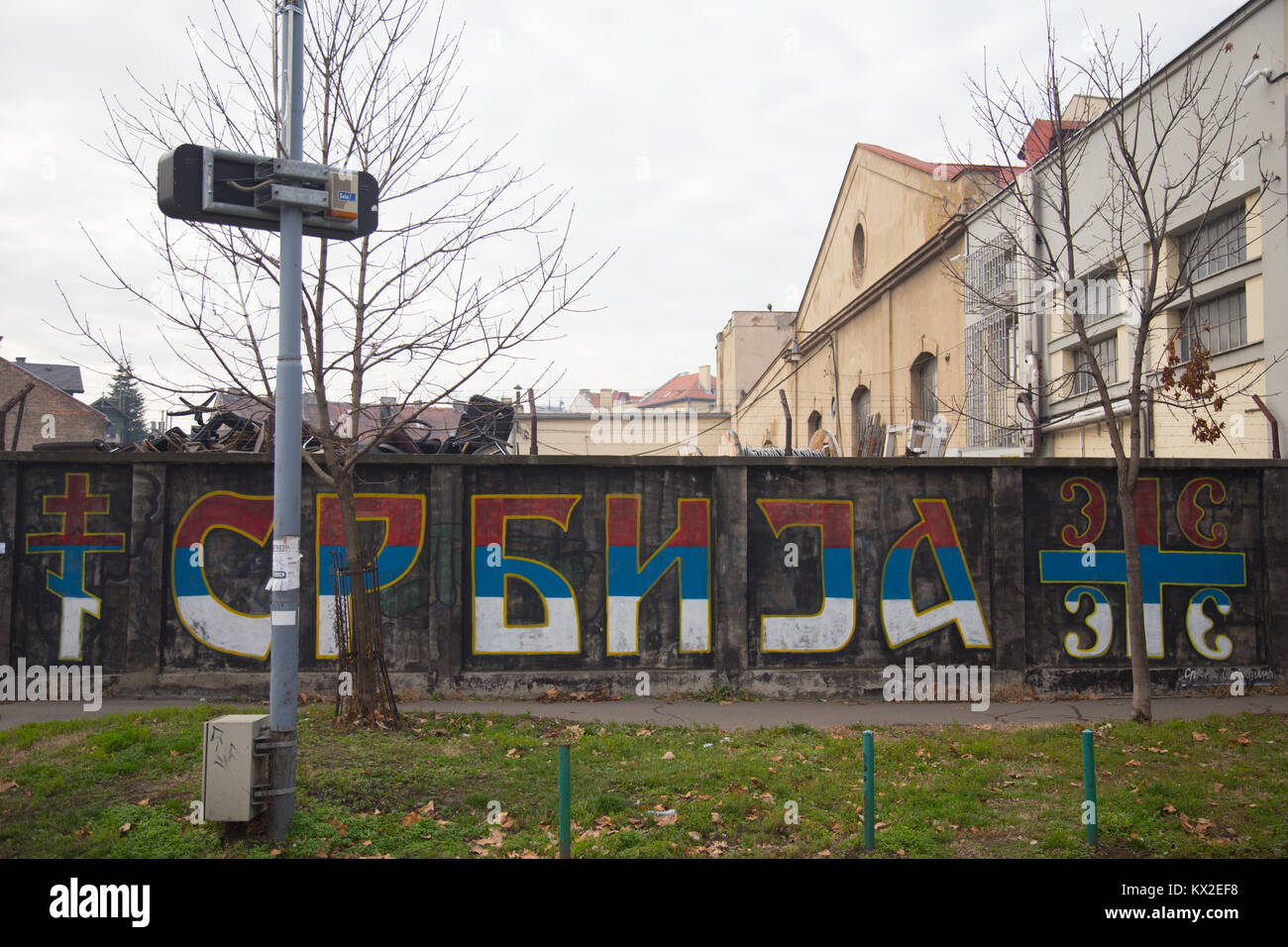 Mural graffiti with orthodox cross and name Serbia written in Serbian ...