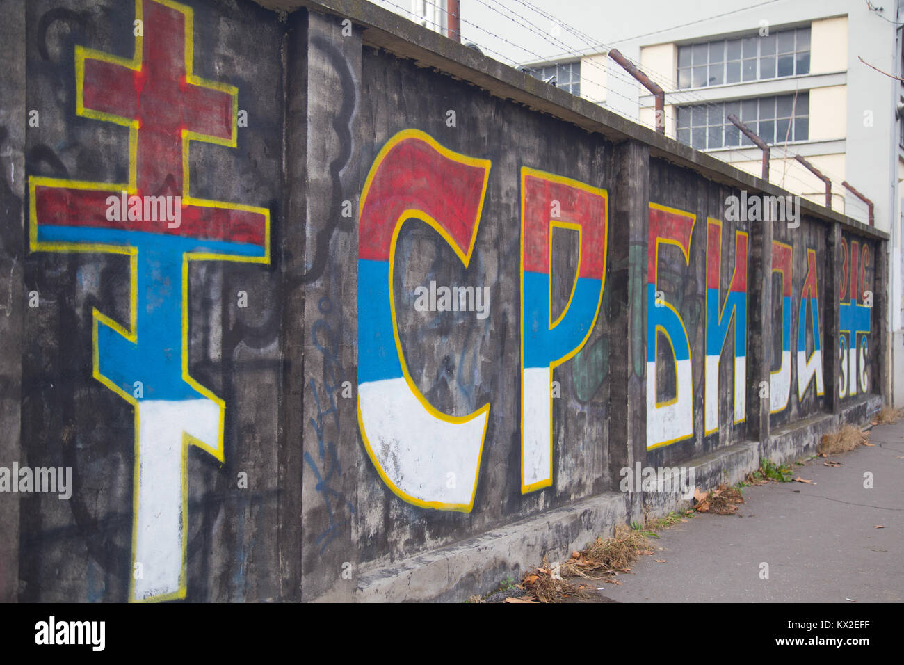 Mural graffiti with orthodox cross and name Serbia written in Serbian ...