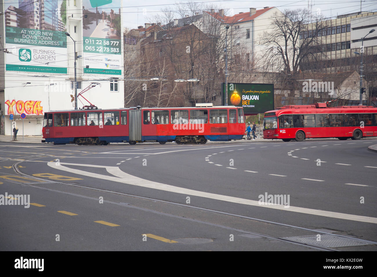 Old Red Tatra KT4 tram and red Belarusian made Belkamunmash ACSM-321 large capacity low-floor ...