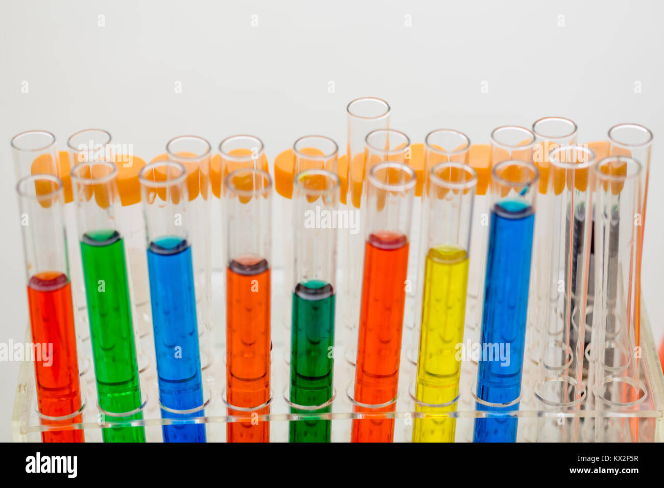Rows of colorful test tubes on lab table Stock Photo - Alamy